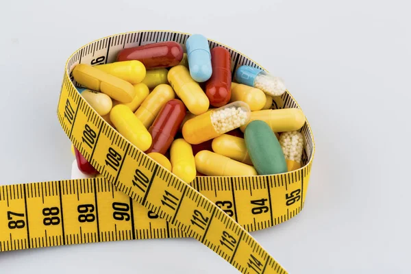 Tablets and measuring tape — Stock Photo © ginasanders #60770505