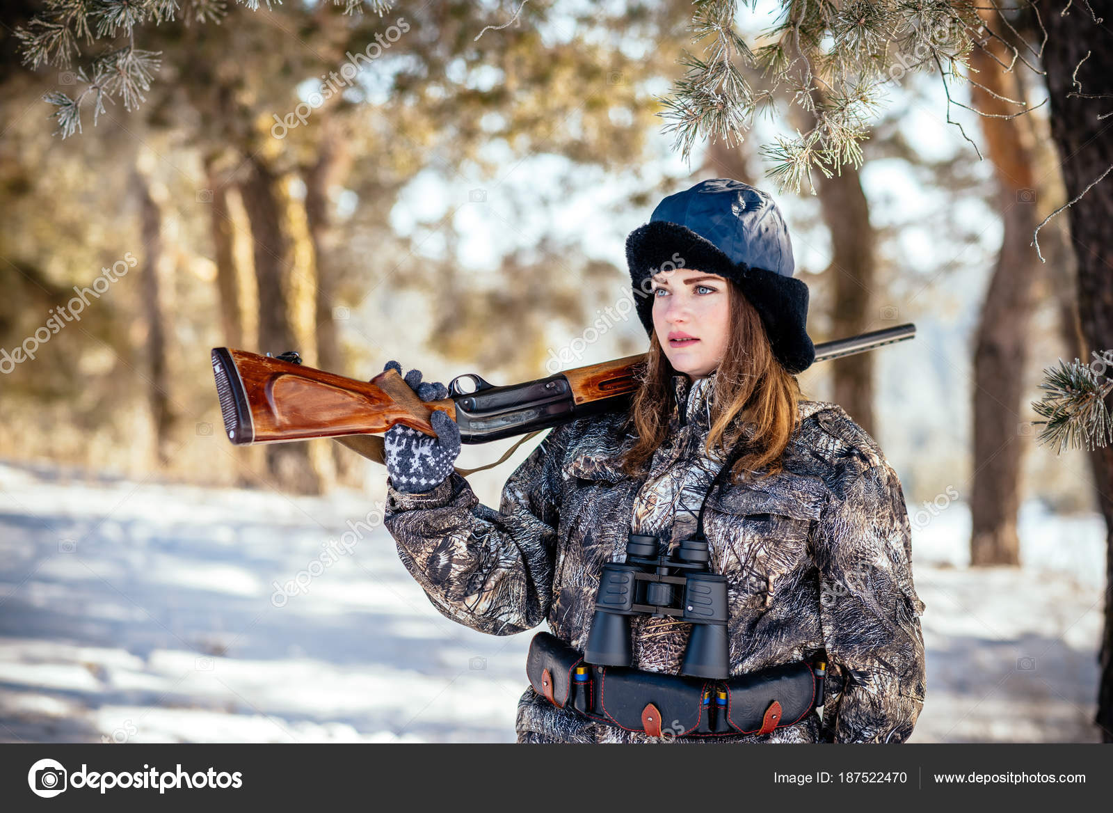 A beautiful hunter in a camouflage suit walks through the woods — Stock Photo © markhipov #187522470