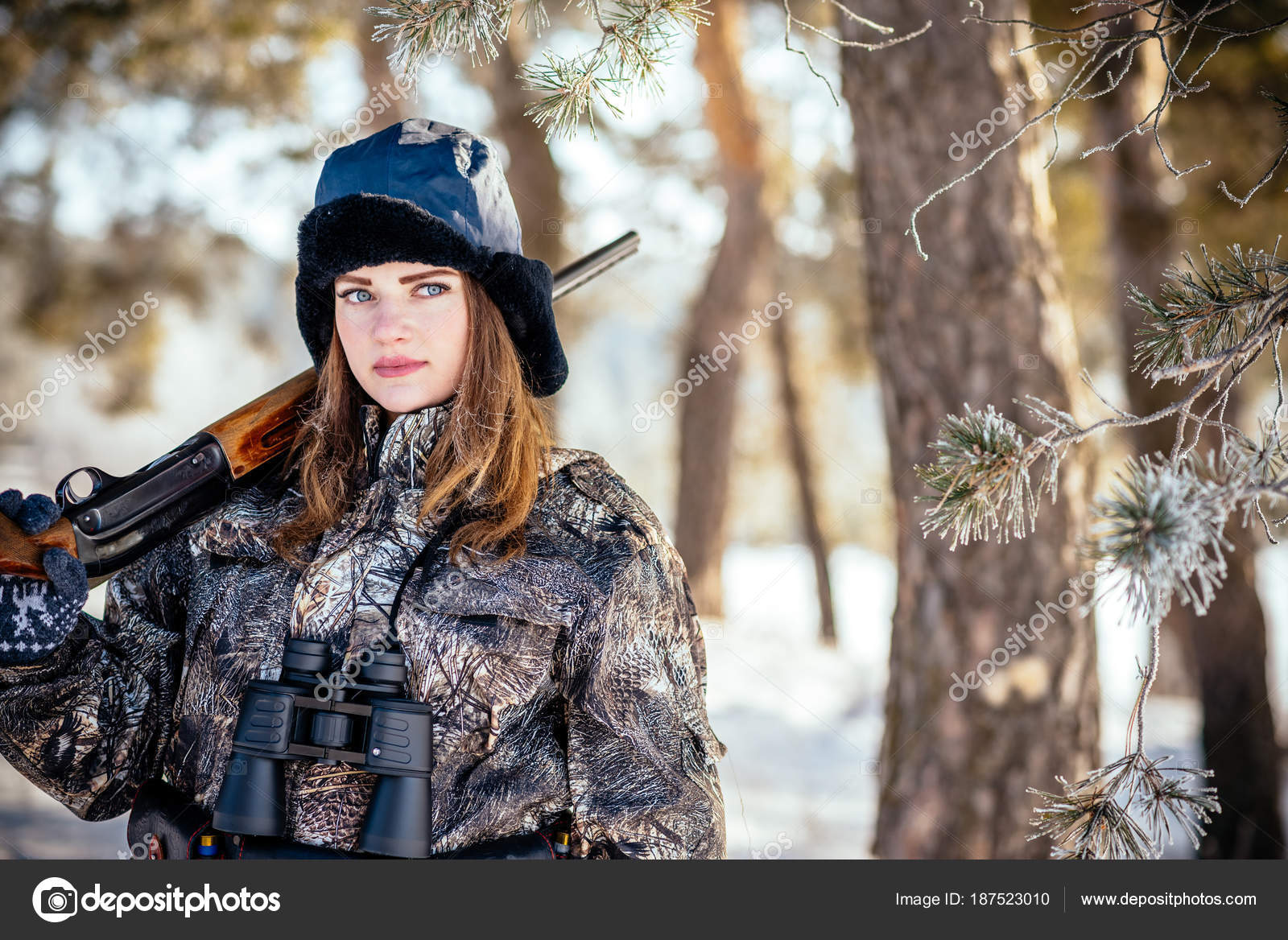 A beautiful hunter in a camouflage suit walks through the woods — Stock Photo © markhipov #187523010