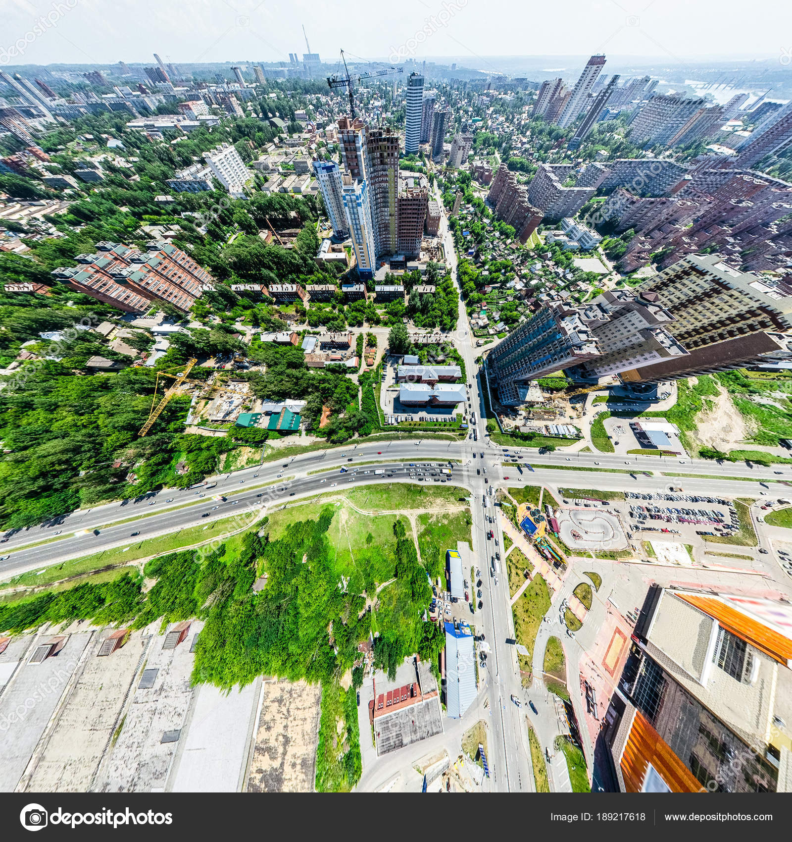 Aerial city view with crossroads and roads, houses, buildings, parks ...