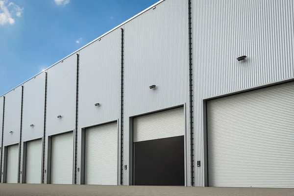 Warehouse exterior with shutter doors — Stock Photo © phonlamai #159505164