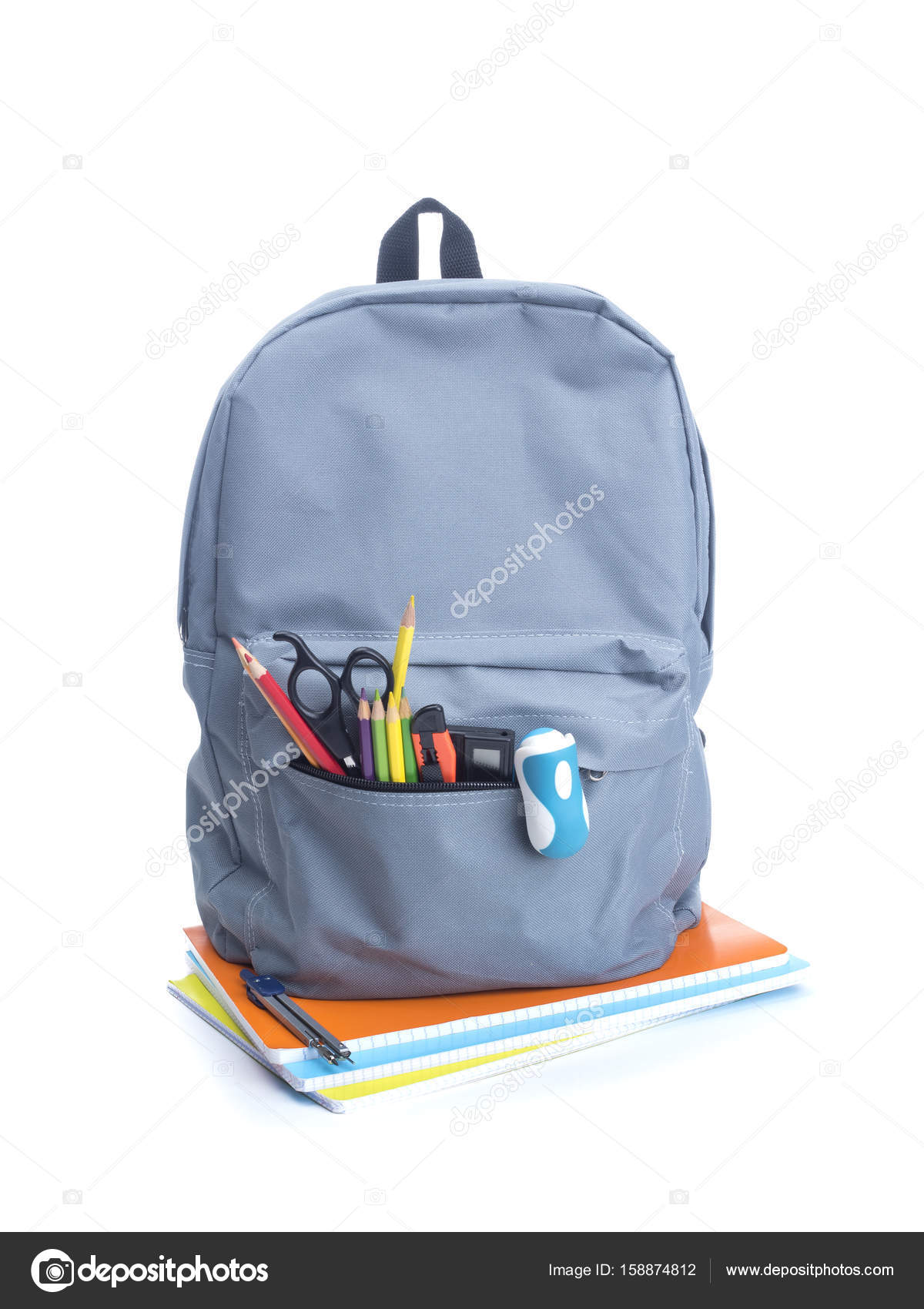 Backpack with school supplies on top of notebooks Stock Photo by ...