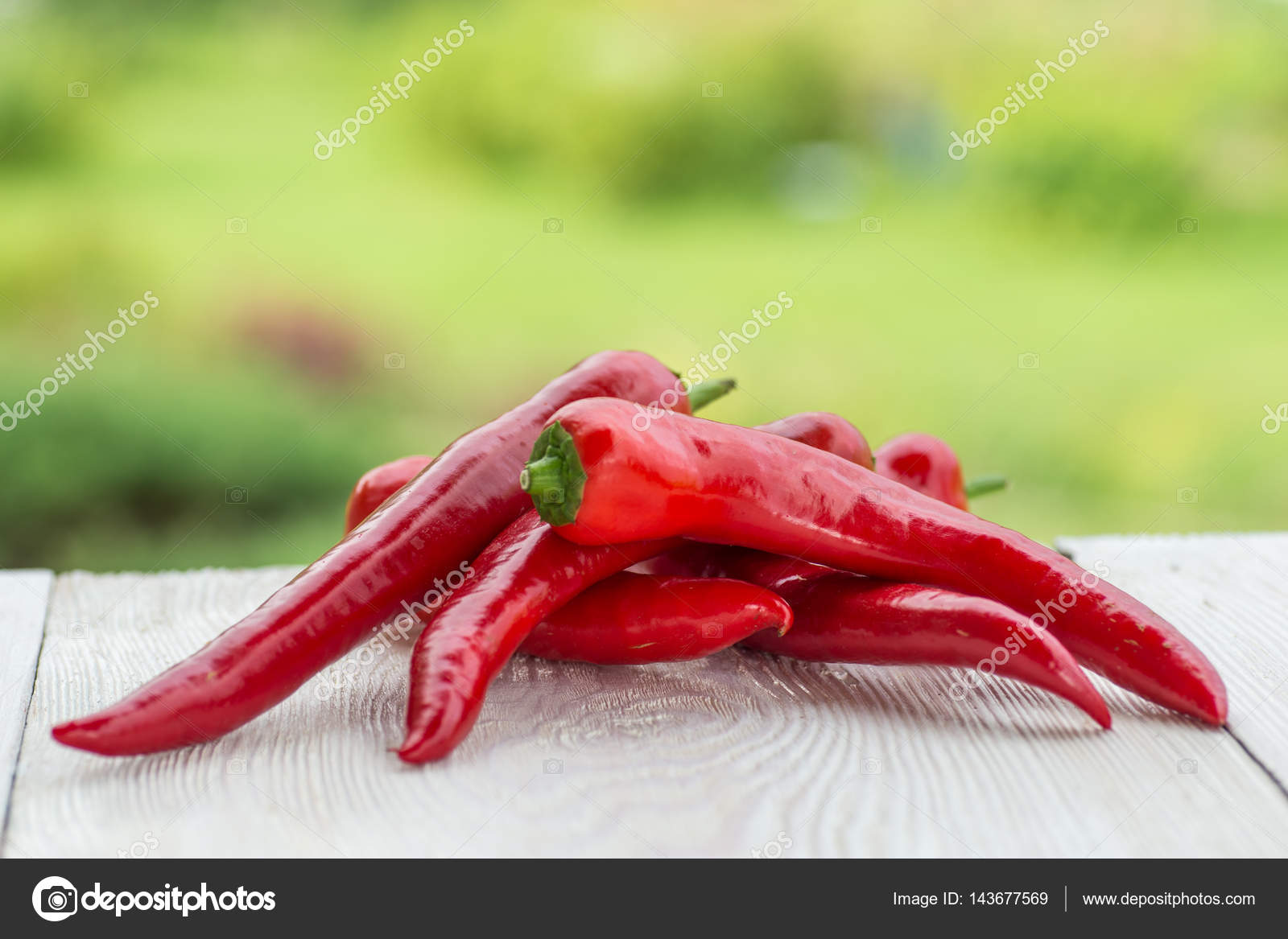 Red paprika with chilli peppers on wooden background Stock Photo by ...