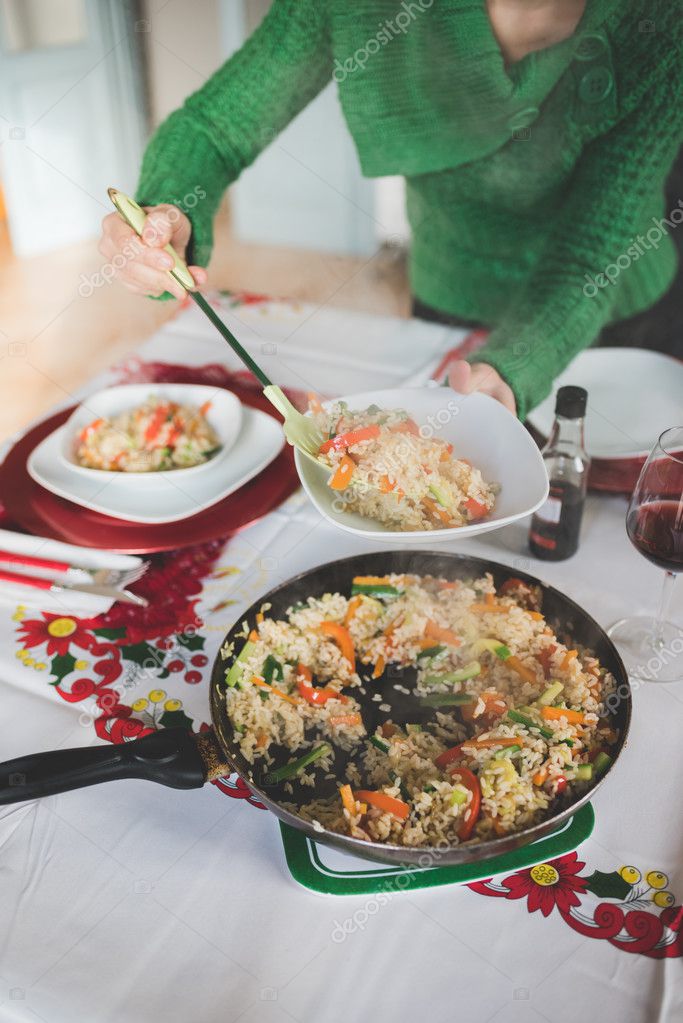 Girl serving rice and vegetables Stock Photo by ©peus 126577422