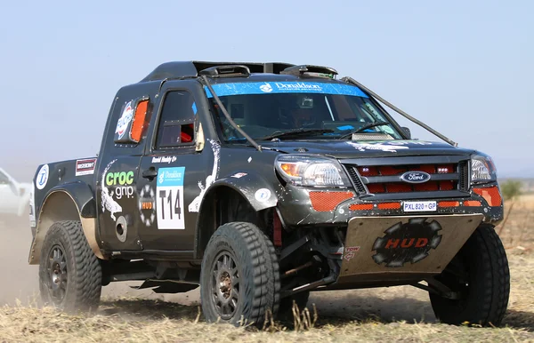 Forty Five degree close-up view of Speeding black Ford Ranger ra ...