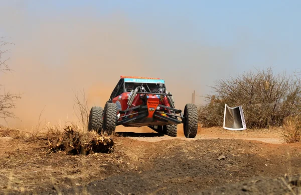 Front view close-up of red Aceco rally car at road crossing - Stock ...