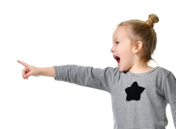 Young girl kid surprised yelling shouting pointing finger at the corner ...