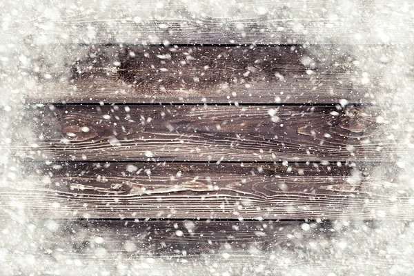 The brown wood texture with snow flakes over it. Winter background ...