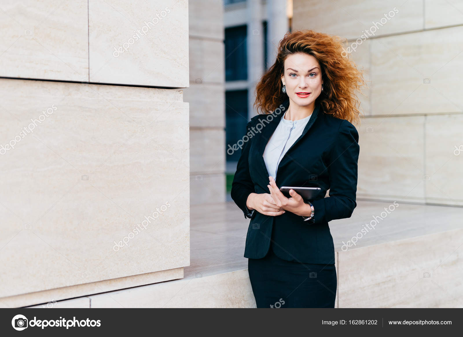 Young successful businesswoman in elegant clothes, having luxuriant ...