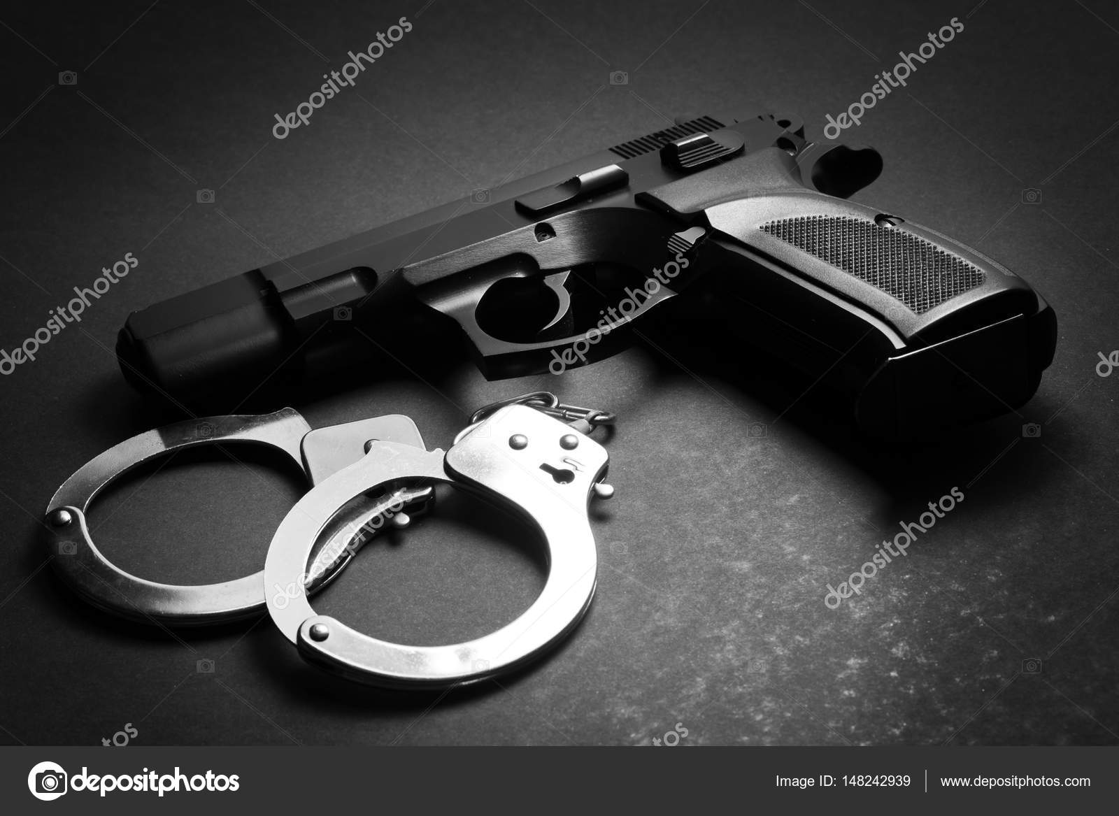 Gun with handcuffs Stock Photo by ©mblach 148242939