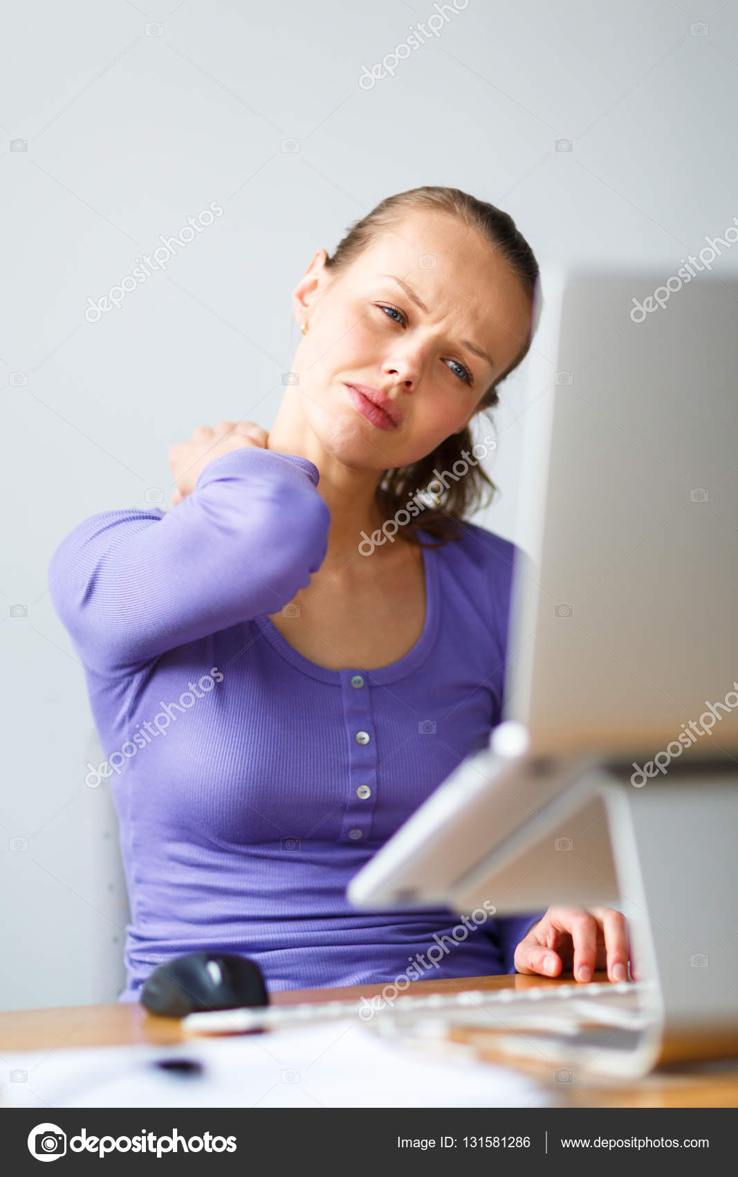 Working too hard - young woman working on a computer at an office ...