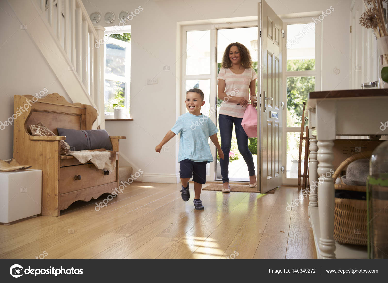 Excited Boy Returning Home From School With Mother Stock Photo by ...