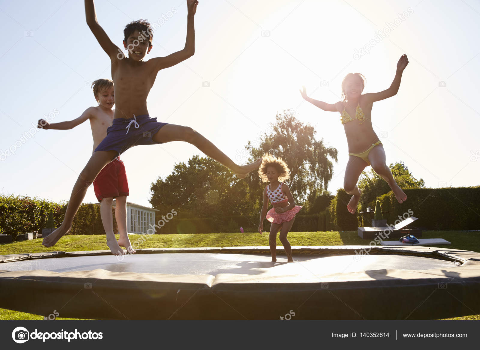Children Having Fun On Trampoline — Stock Photo © monkeybusiness #140352614 Children Having Fun On Trampoline — Stock Photo © monkeybusiness #140352614