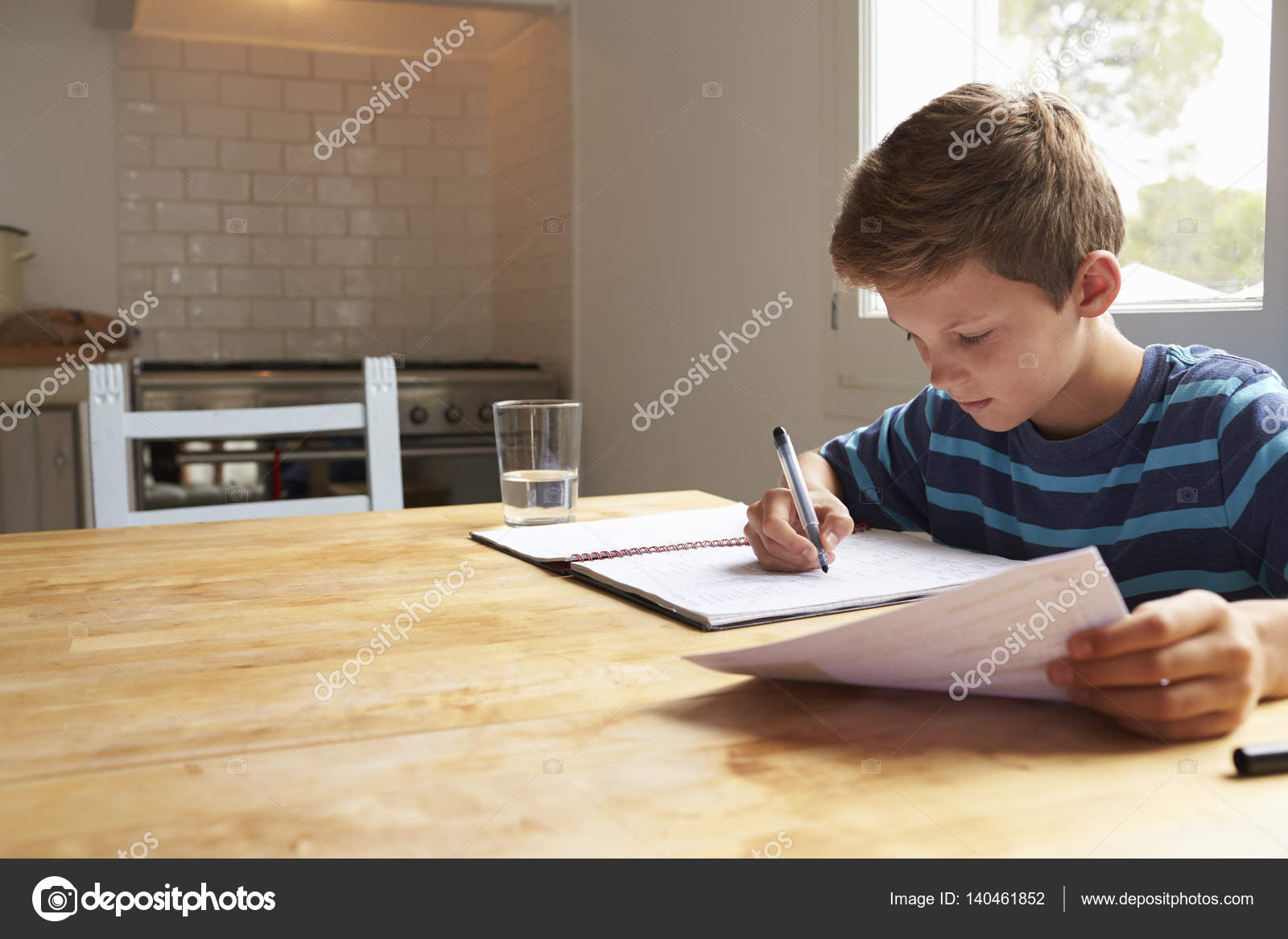 Boy Sitting At Kitchen Table Stock Photo by ©monkeybusiness 140461852