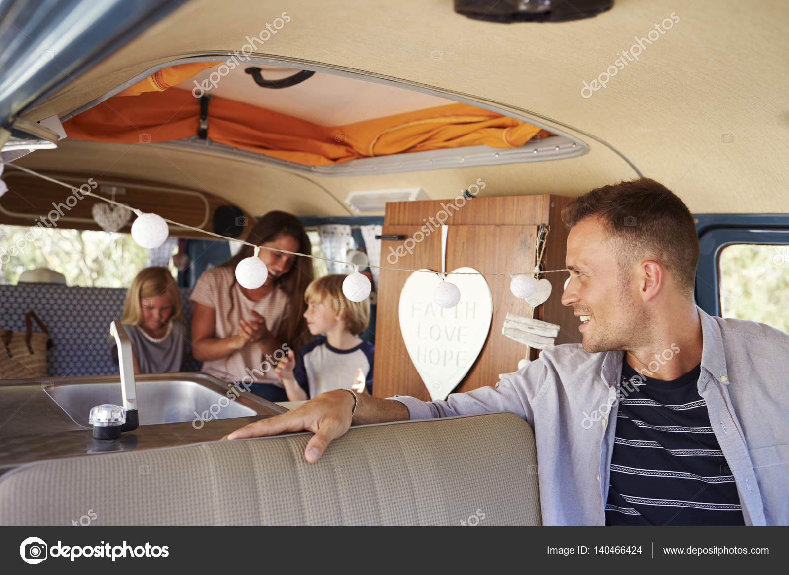 Family sitting inside camper van — Stock Photo © monkeybusiness #140466424