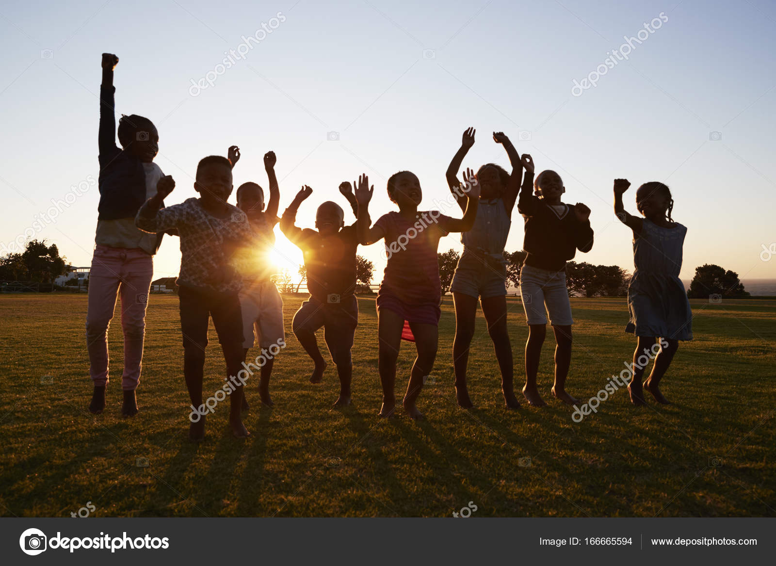 School kids jumping at sunset Stock Photo by ©monkeybusiness 166665594