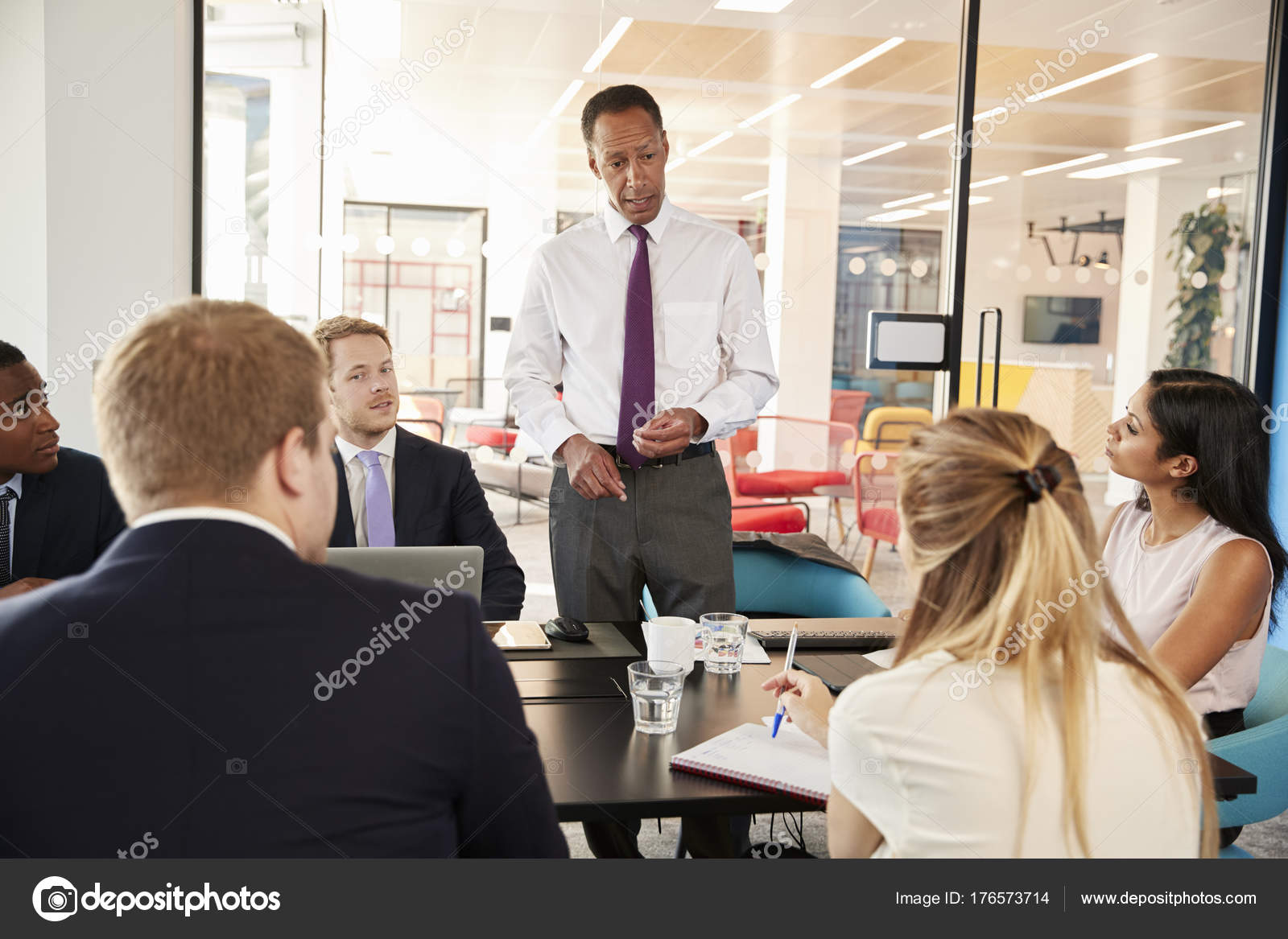 Black male manager addressing colleagues — Stock Photo © monkeybusiness ...