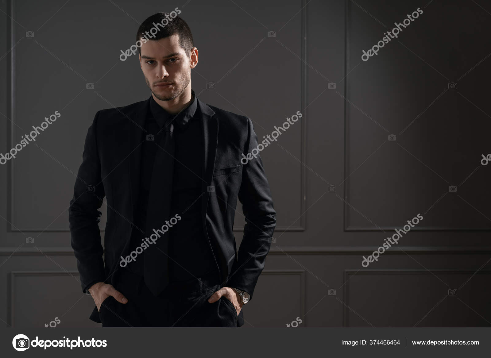 Young handsome businessman in black shirt and black suit Stock Photo by ...