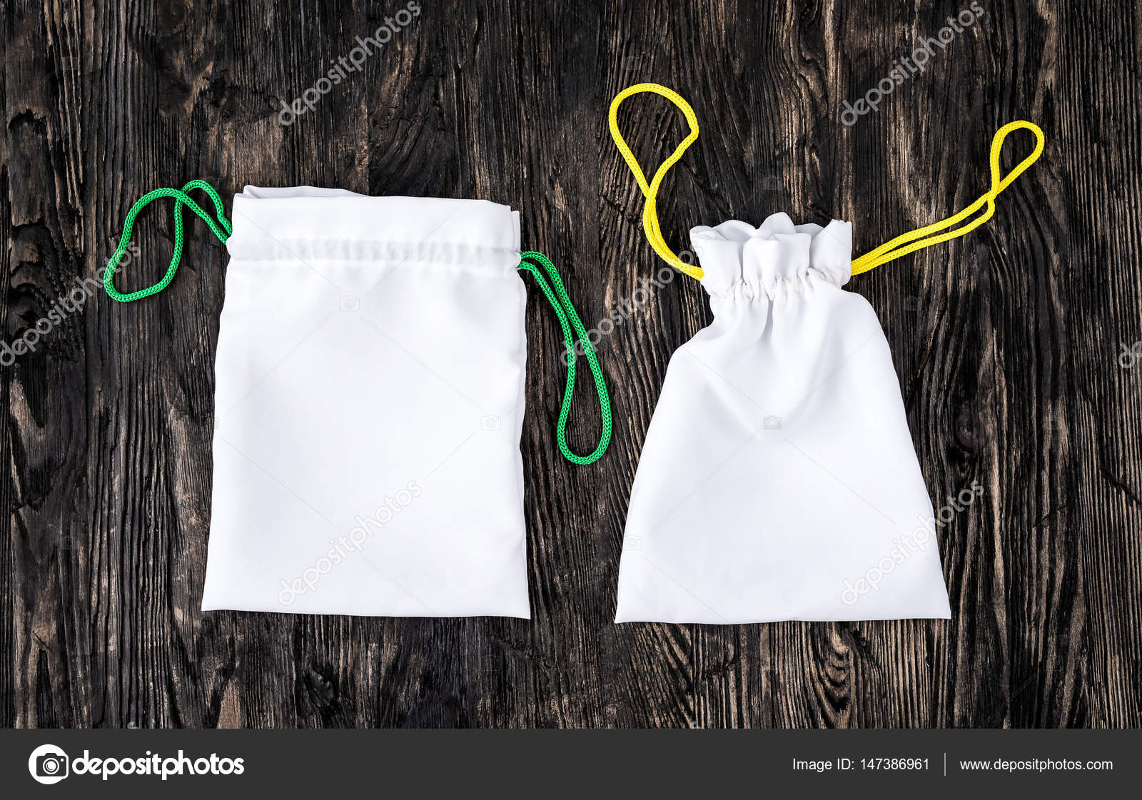 Two empty white gift bags on dark wooden surface Stock Photo by ...