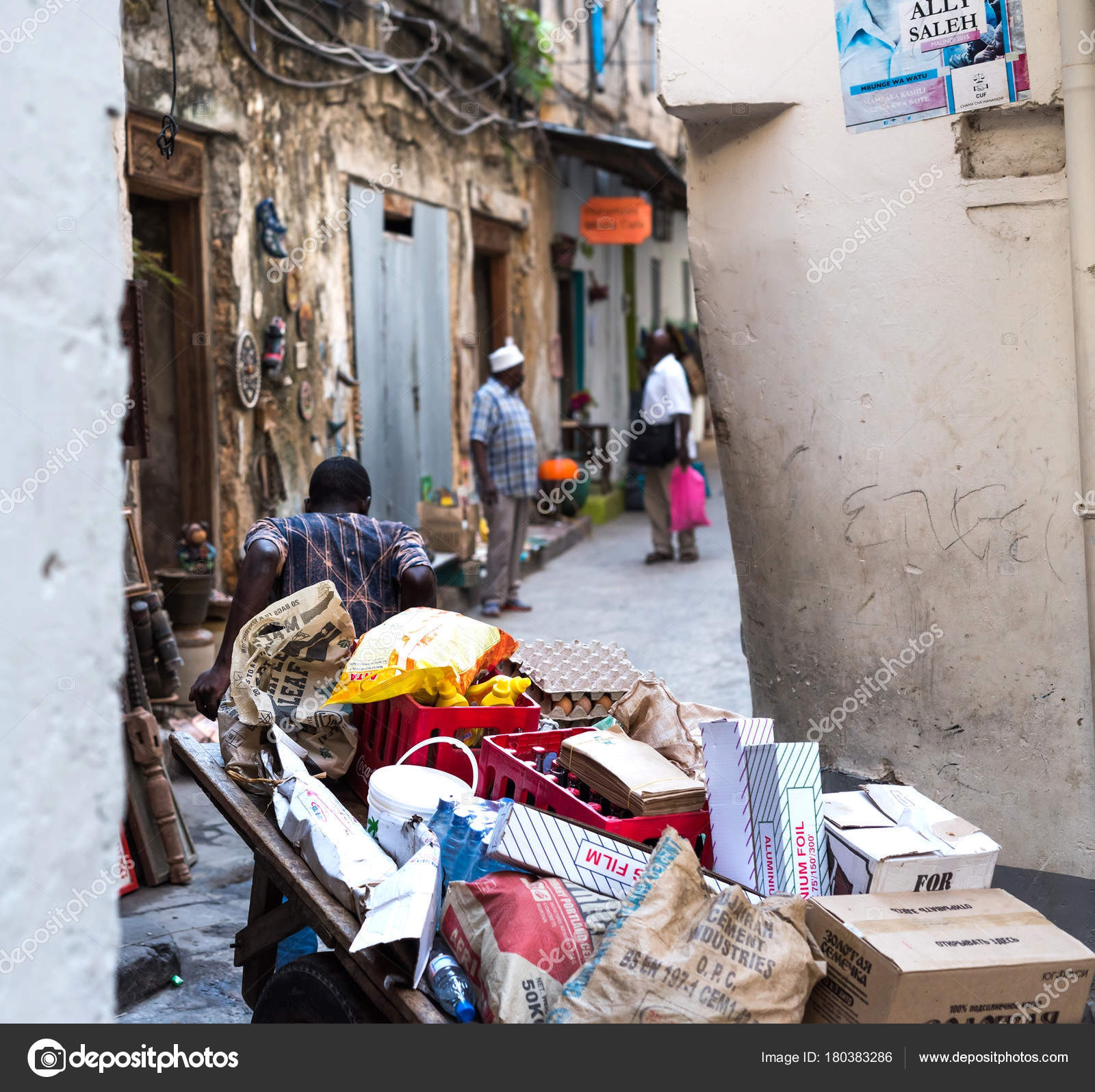 Man pulling overloaded pushcart full of goods, zanzibar – Stock ...