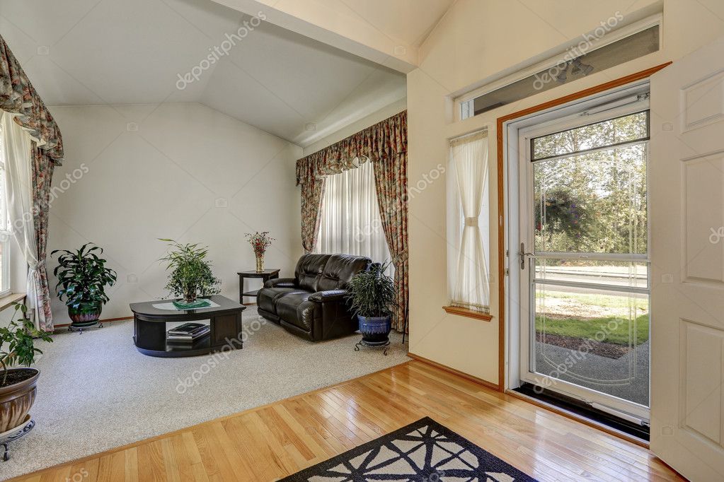 Cozy sitting area with elegant window curtains and vaulted ceiling ...