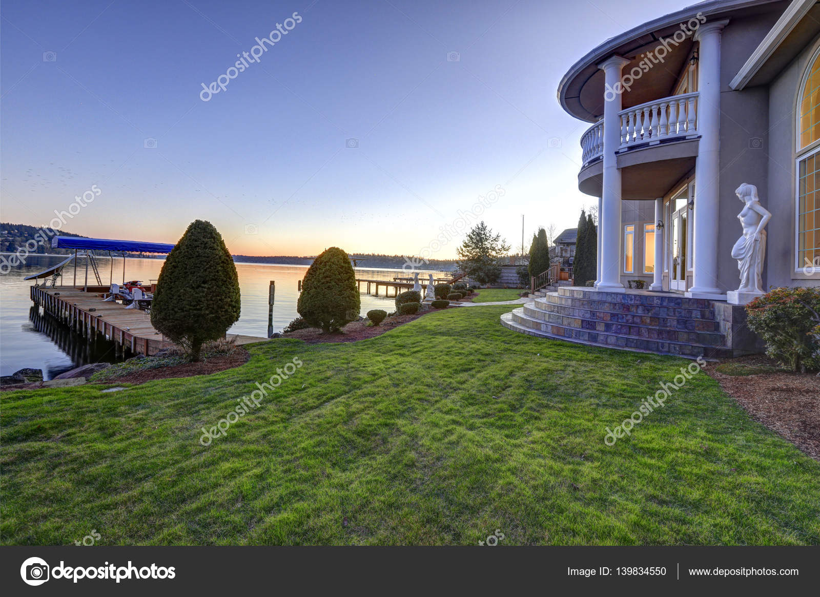 Luxurious waterfront home backyard view at sunset — Stock Photo ...