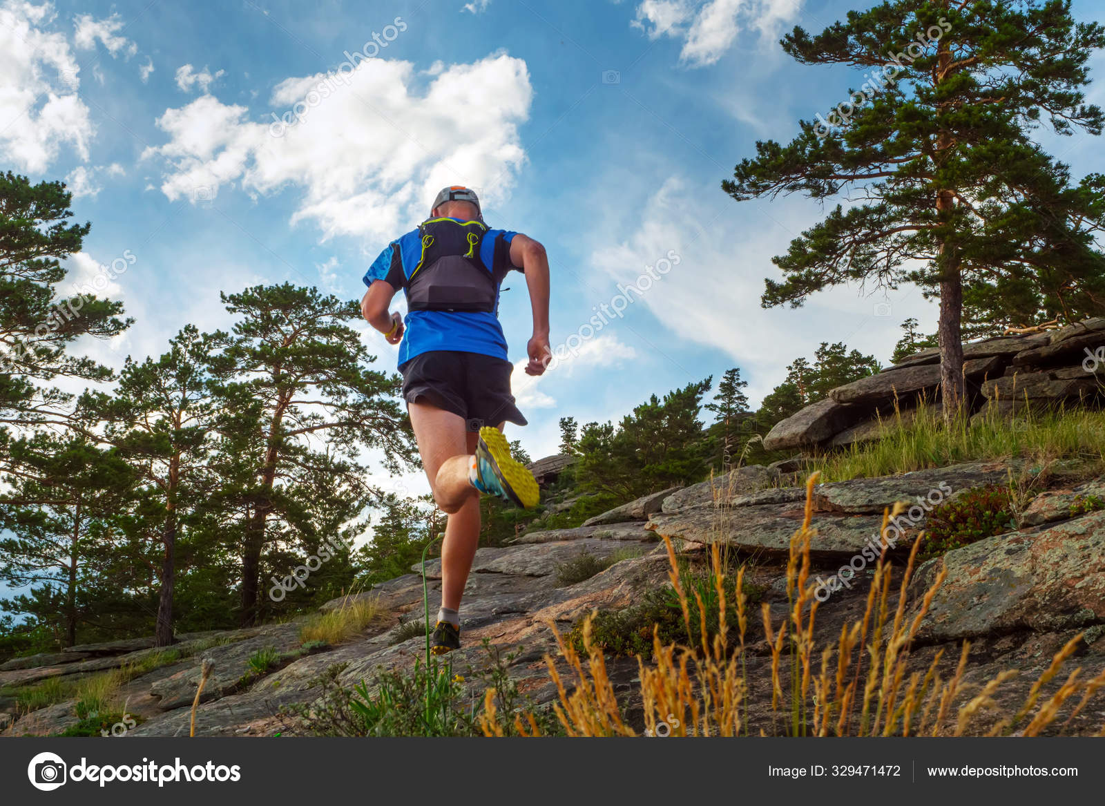 Male runner running on a mountain trail Stock Photo by ©vjSniper 329471472