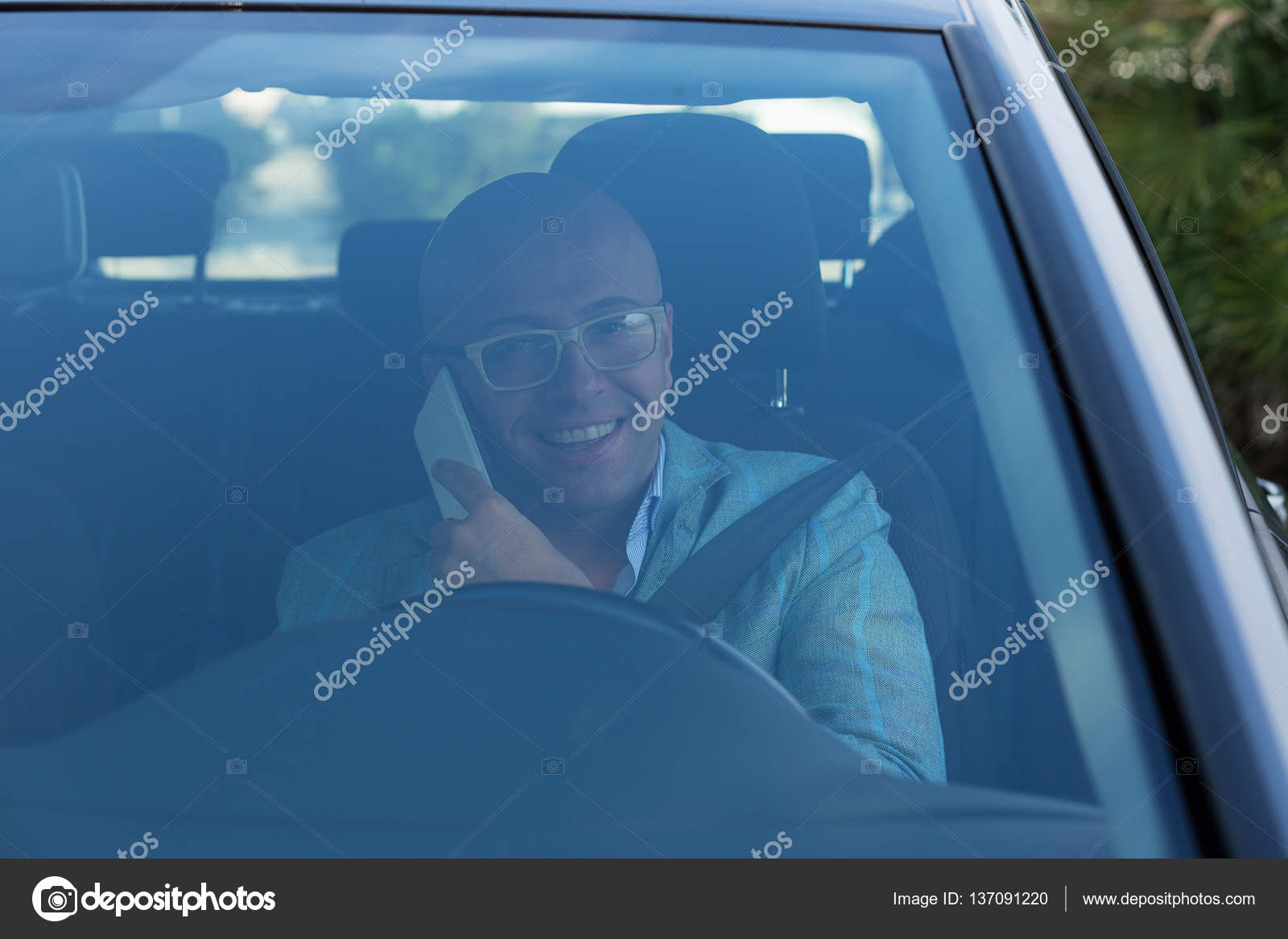 Front window view handsome young man talking on mobile phone while ...