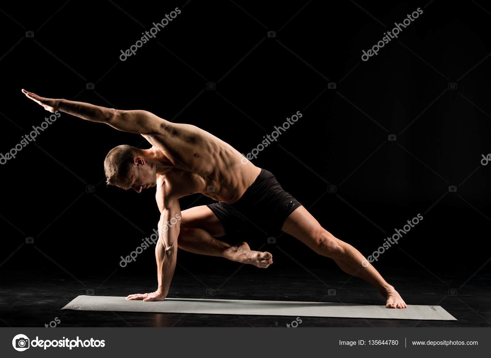 Man standing in yoga position — Stock Photo © OlgaZakrevskaya #135644780