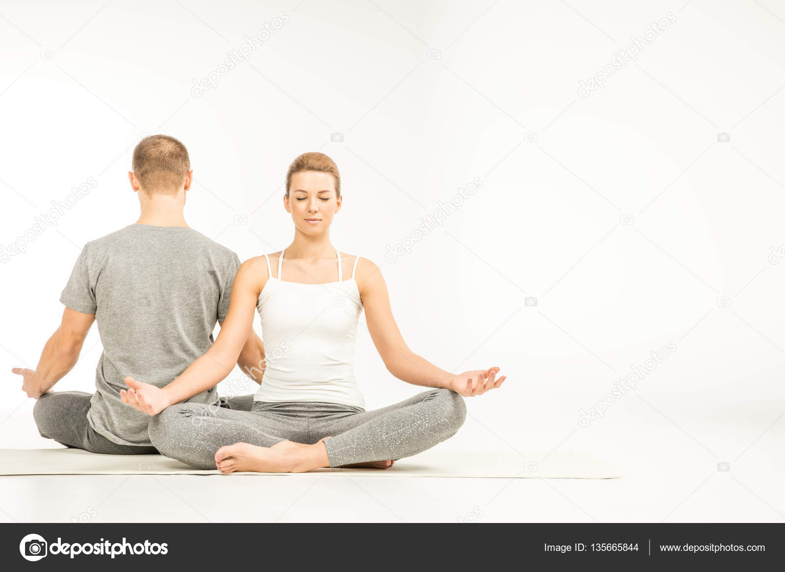 Couple sitting in lotus position — Stock Photo © OlgaZakrevskaya #135665844
