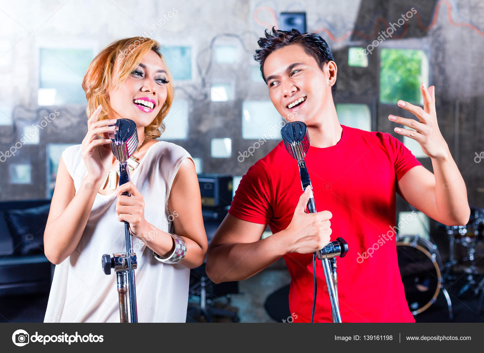 Asian singer producing song in recording studio — Stock Photo © Kzenon ...