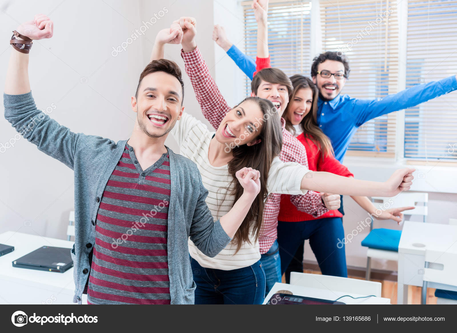 Group of students having fun at college — Stock Photo © Kzenon #139165686