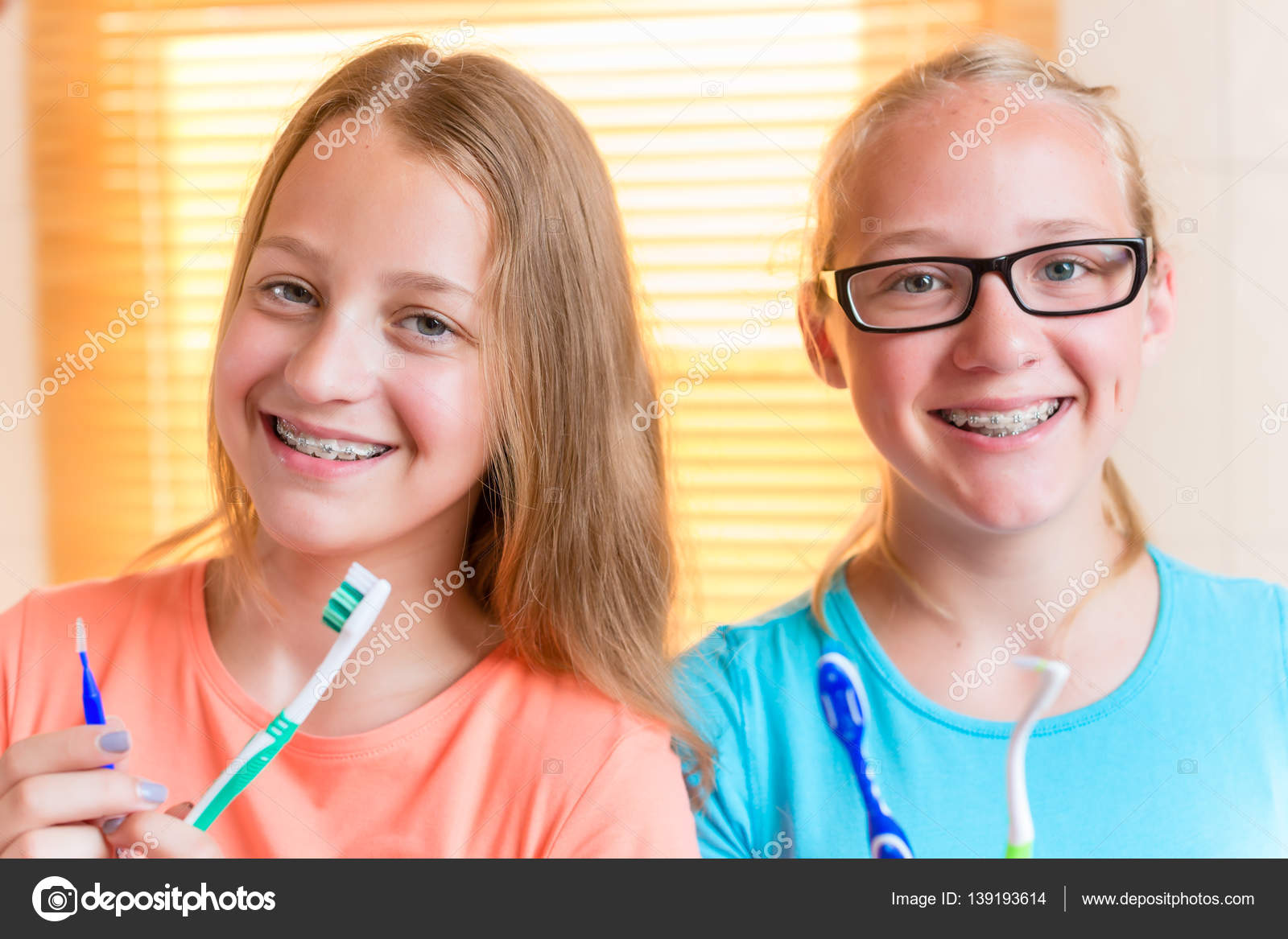 Two girls with dental retainers brushing teeth Stock Photo by ©Kzenon ...