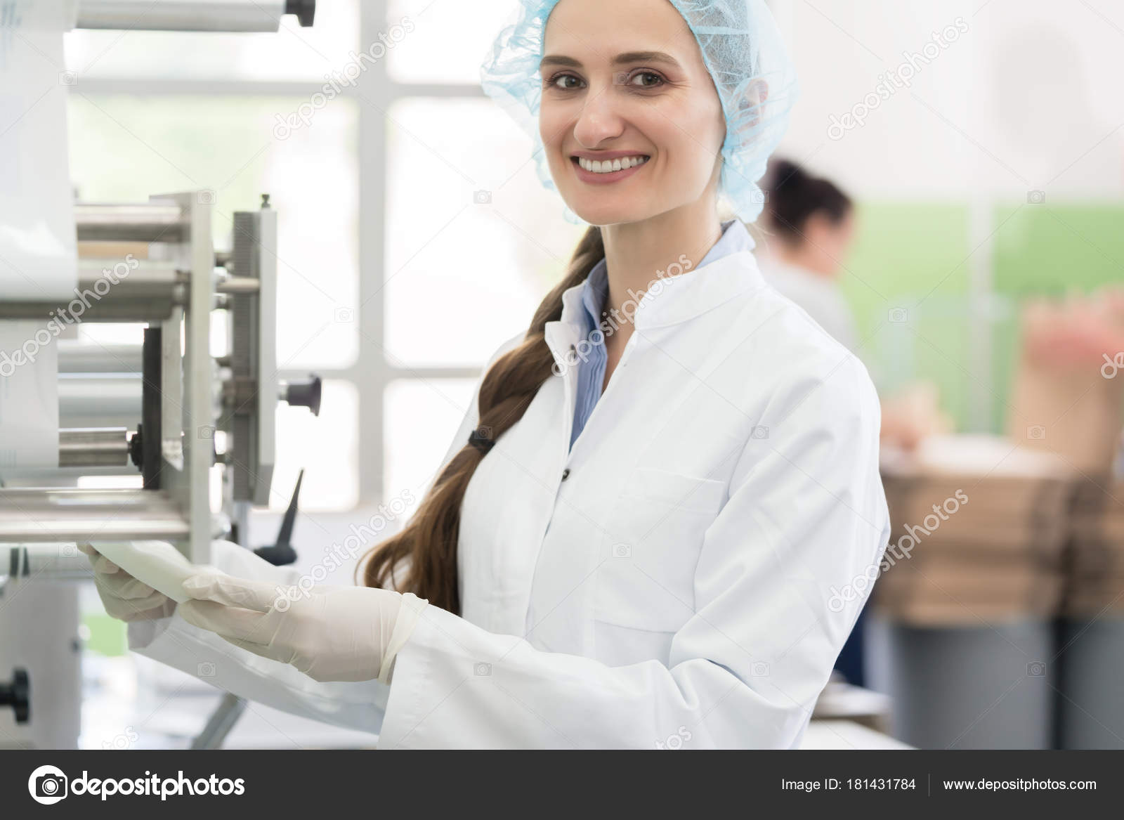 Happy employee wearing lab coat while handling sterile wipes in Stock ...