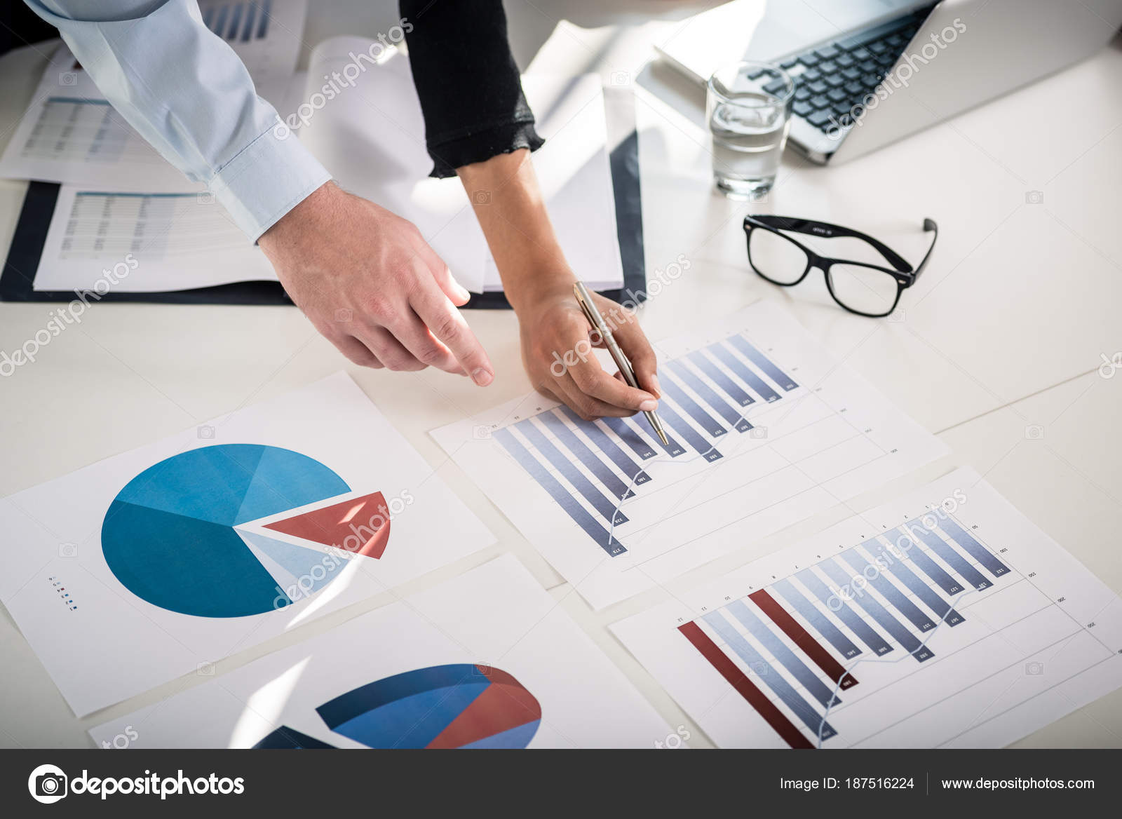 Business experts analyzing statistical bar and pie charts — Stock Photo ...