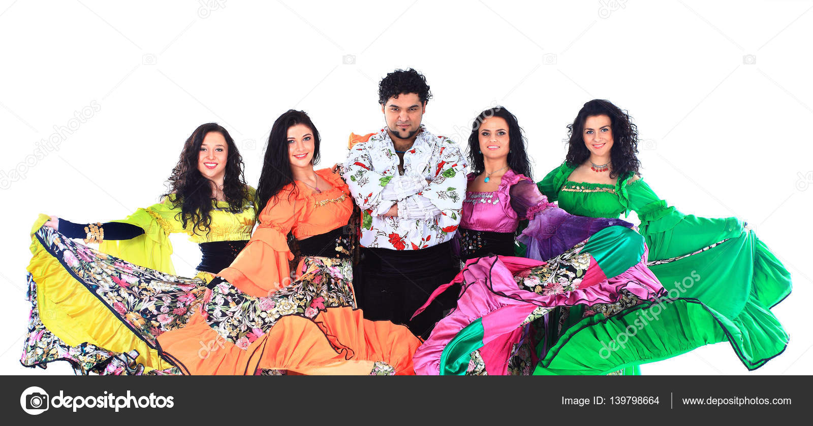 Dance group of gypsies, dancing and waving their magnificent dresses ...