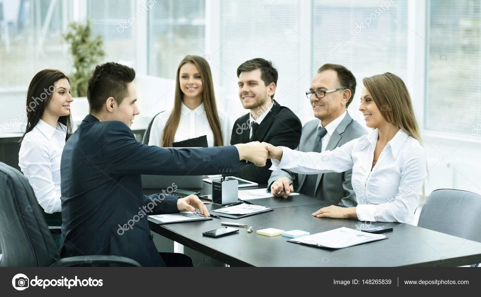 Handshake business partners at a meeting in creative office on the ... Handshake business partners at a meeting in creative office on the ...