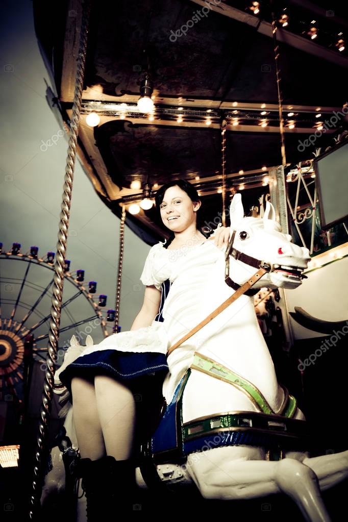Young Woman Enjoying A Carousel Ride — Stock Photo © nullplus #138217480