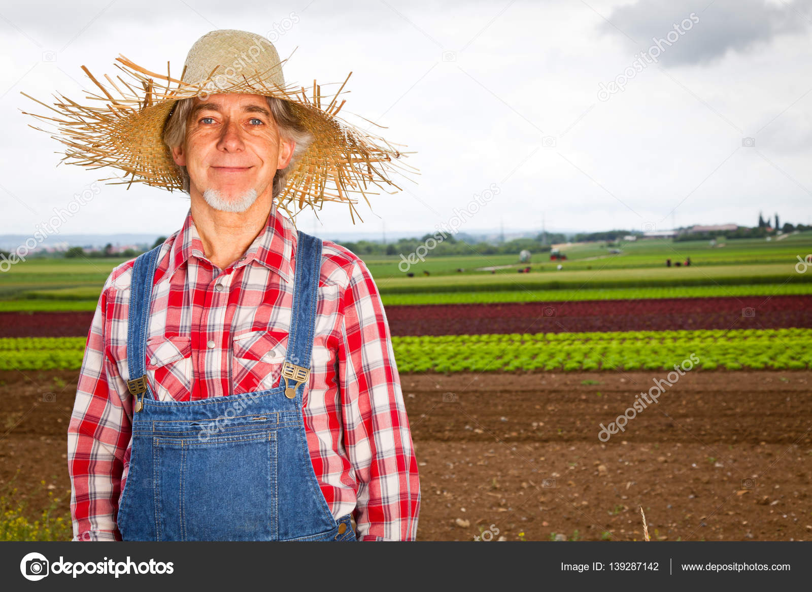 Farmer Standing In Front Of His Field Stock Photo by ©nullplus 139287142