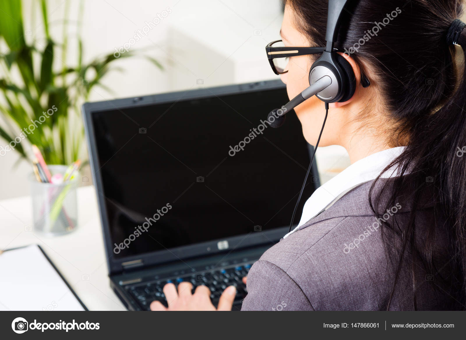 Young Woman Providing It Support Stock Photo by ©nullplus 147866061