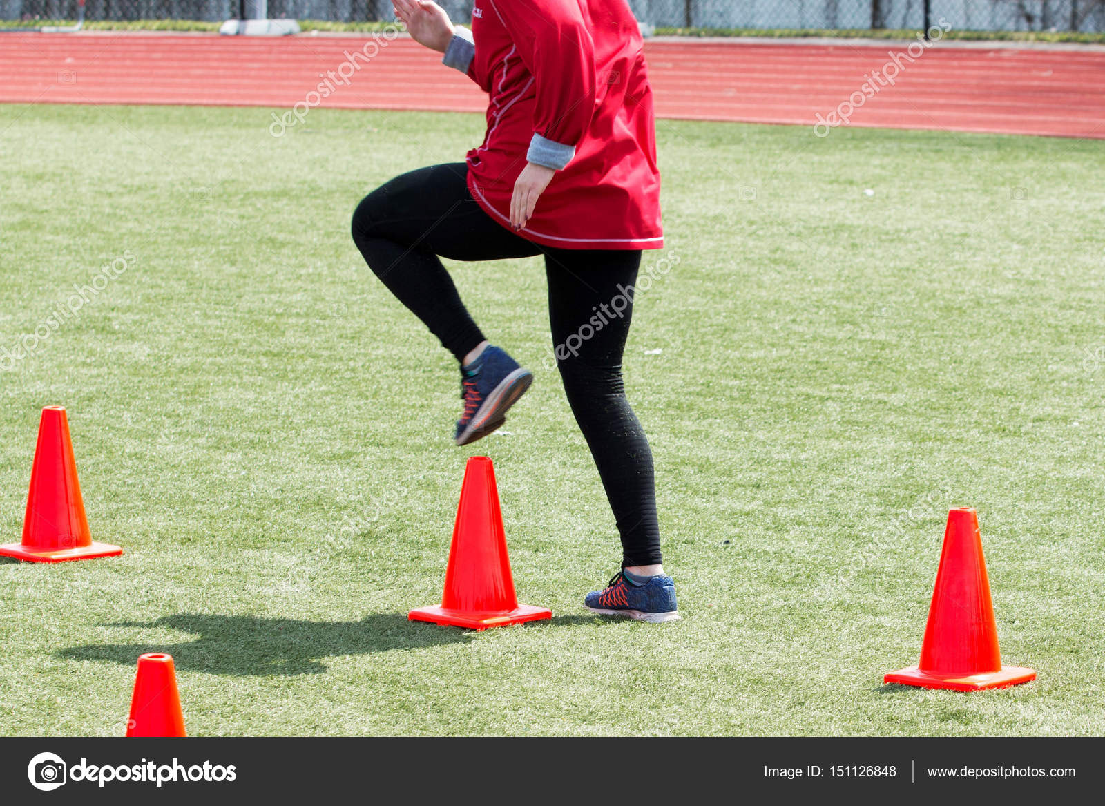 Athlete doing running drills over cones — Stock Photo © WoodysPhotos ...