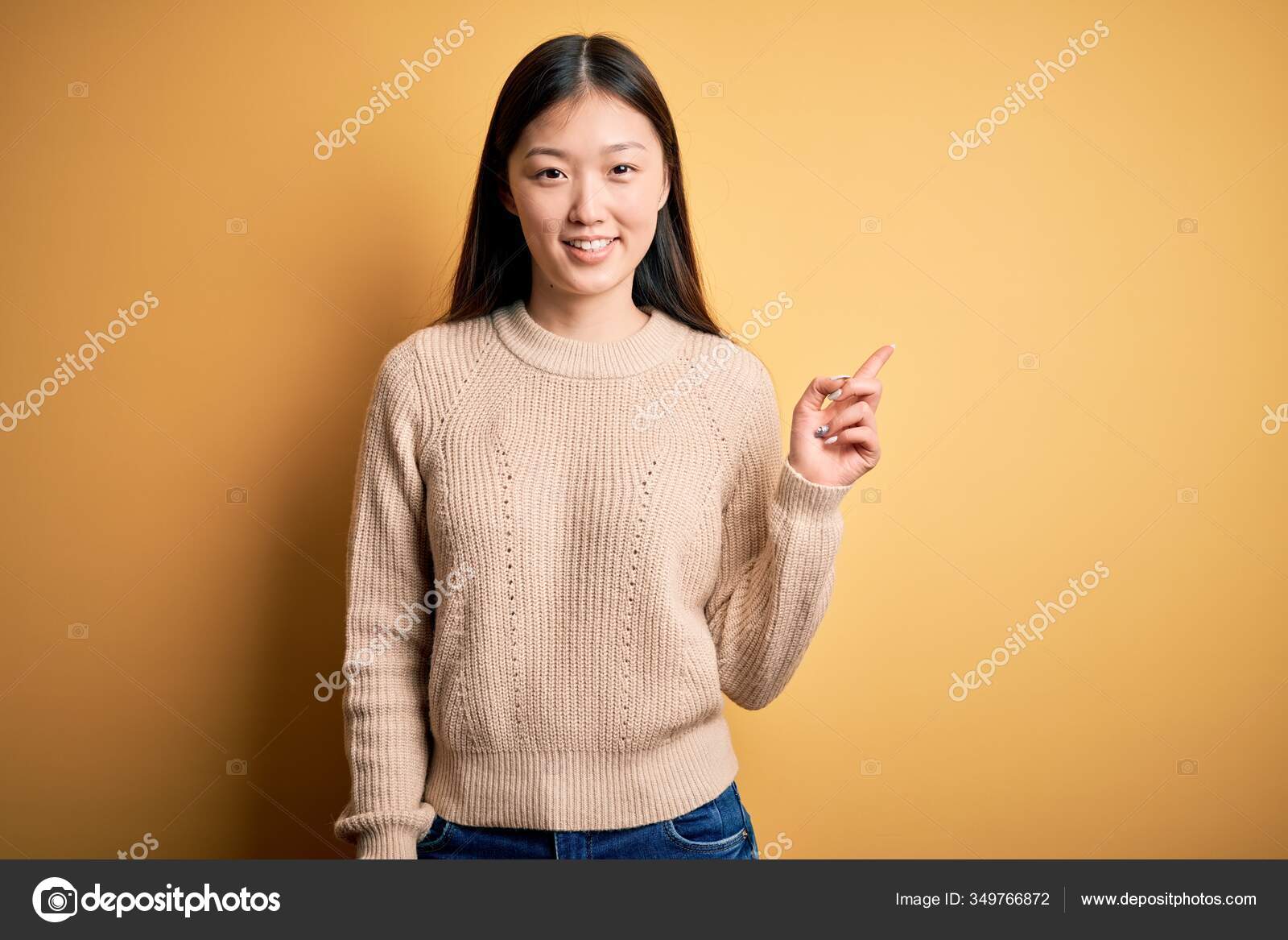 Young Beautiful Asian Woman Wearing Casual Sweater Yellow Isolated ...