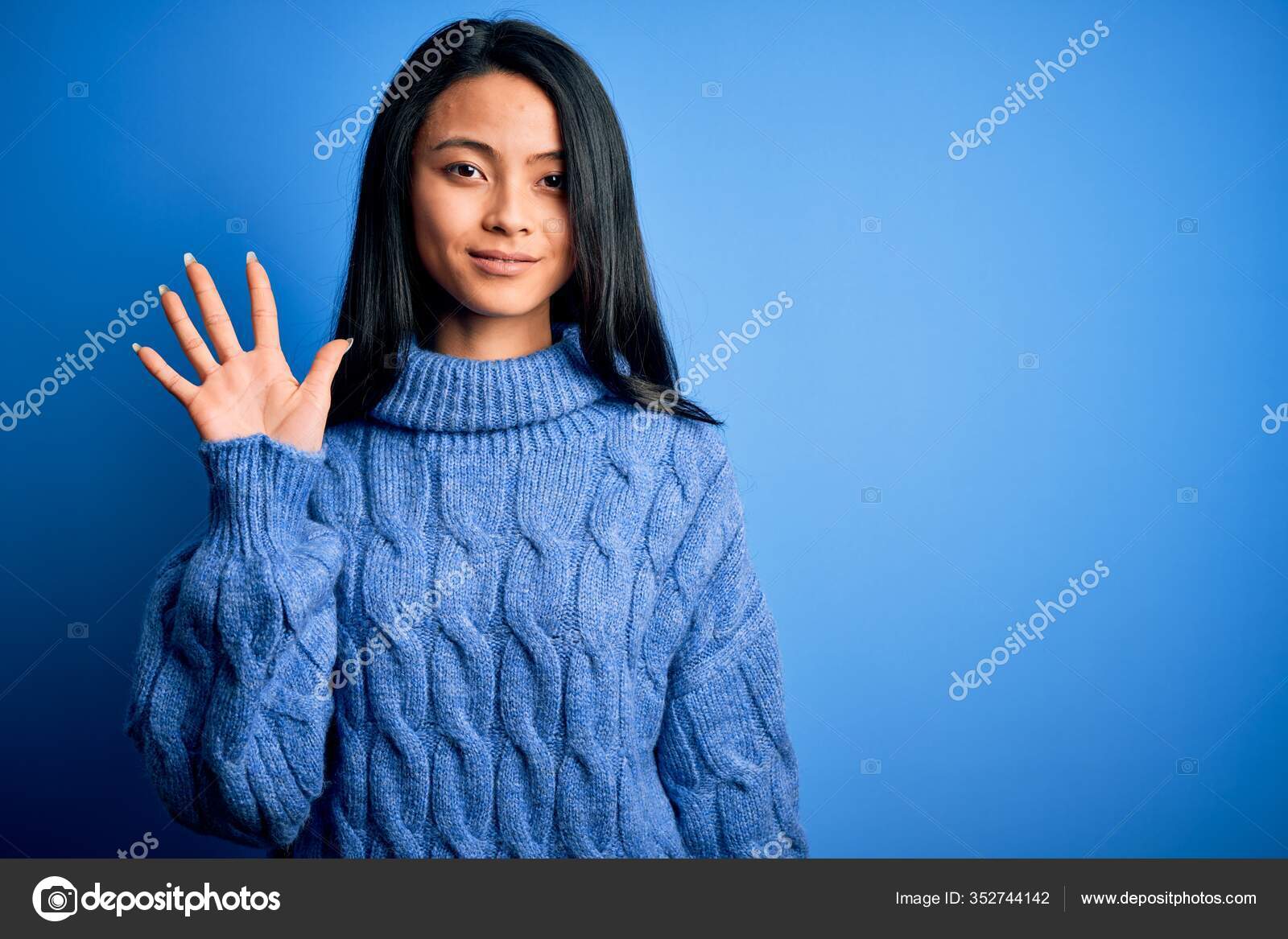 Young Beautiful Chinese Woman Wearing Casual Sweater Isolated Blue ...