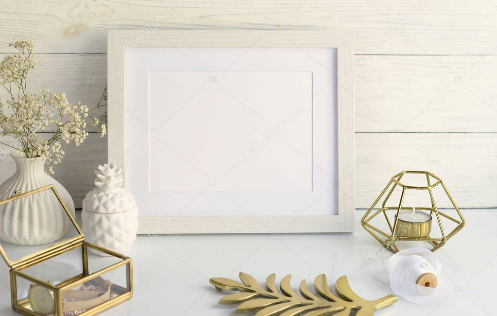 White frame mockup with interior items on white wooden background ...