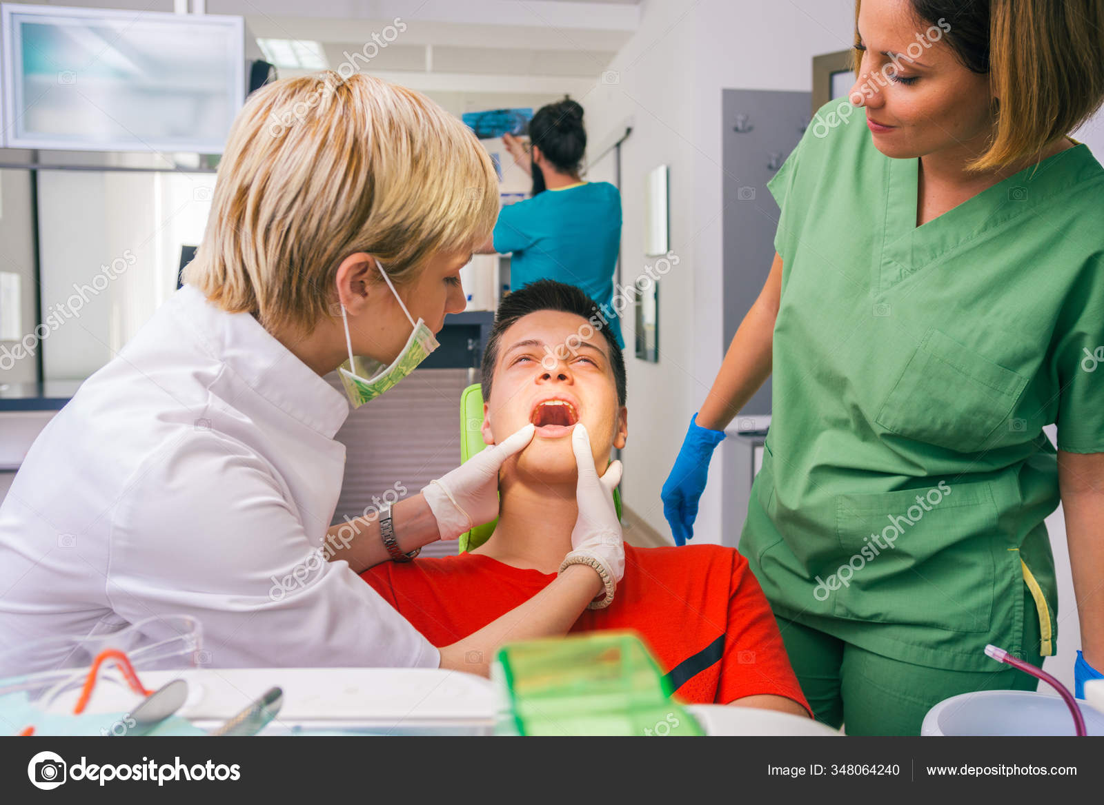 Female Dentist Help Her Dentist Technician Examines Mouth Teeth Teenage ...