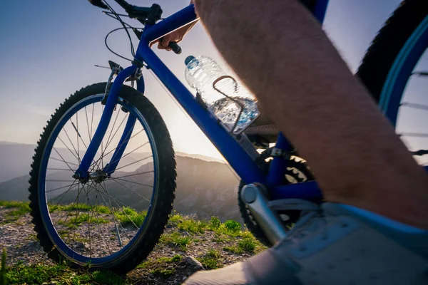 Close up silhouette of an athlete (mountain biker) riding his bi ...