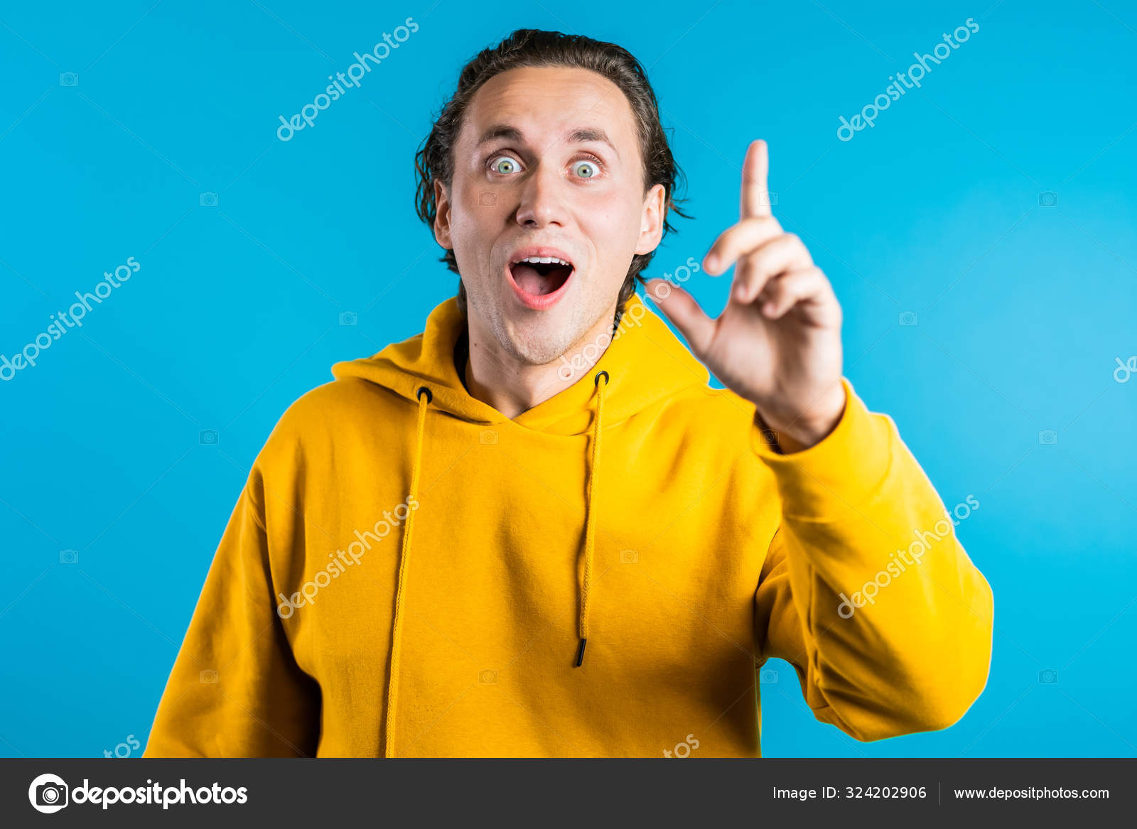 Portrait of young thinking pondering man in yellow having idea moment ...