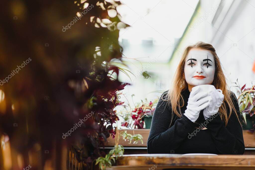 Chica mimo bebe café en París. Mime comediante bebiendo café. 2022