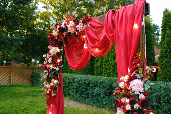 Lilac wedding arch with flowers on ceremony place Stock Photo by ...