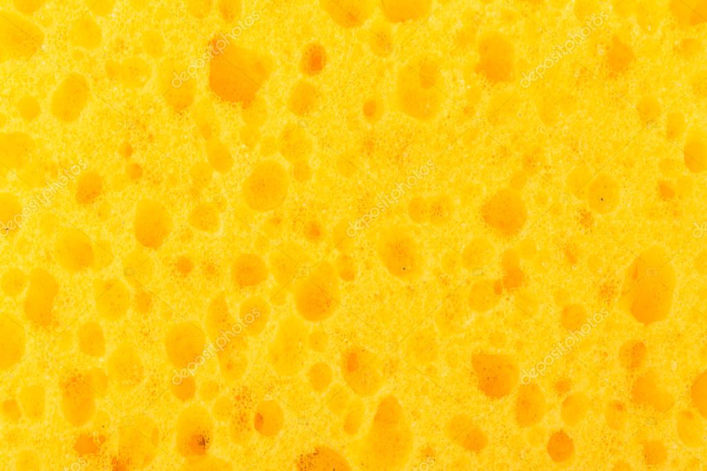 Texture yellow foam rubber, synthetic sponge with large pores, close-up ...